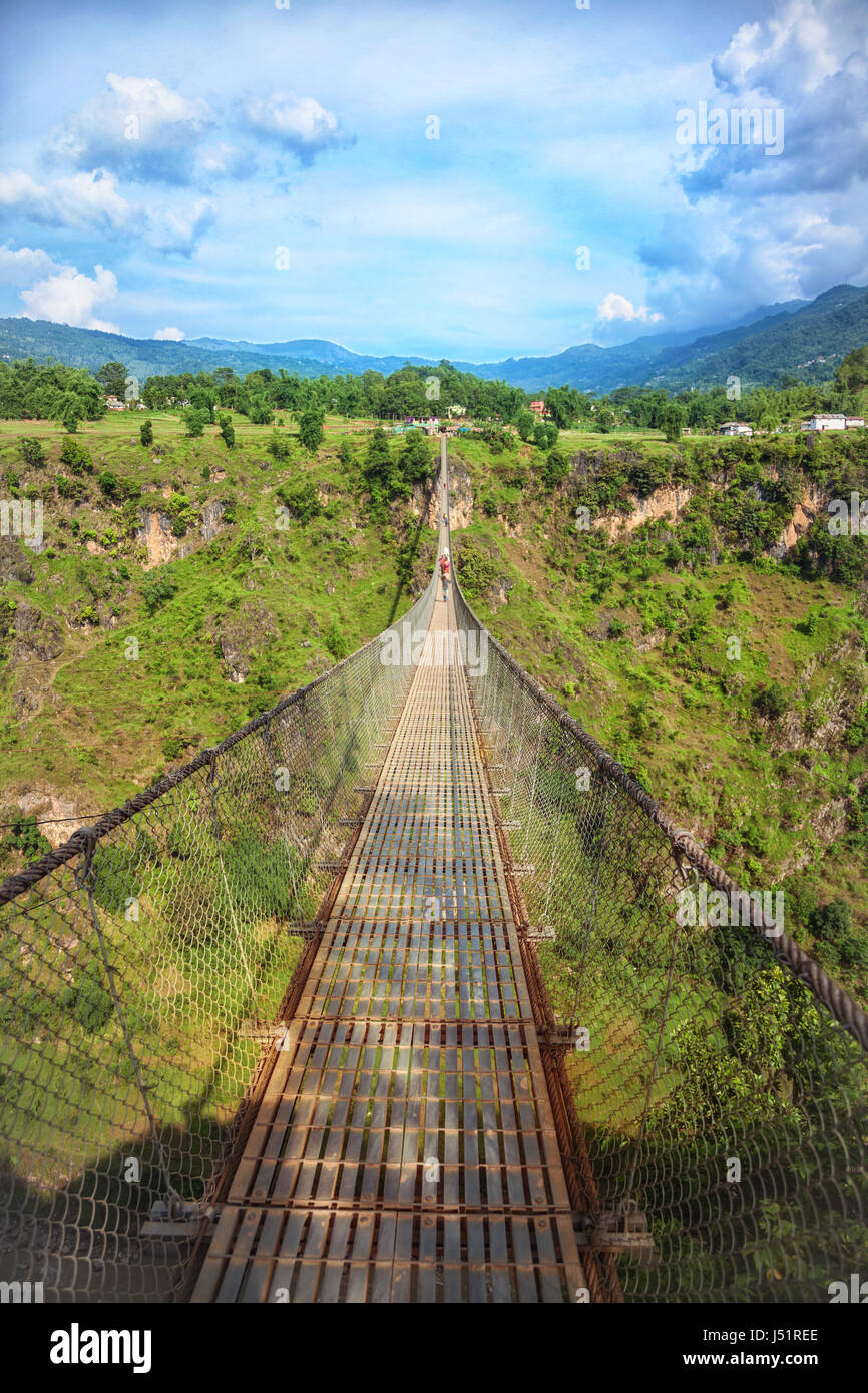 Long suspension bridge over a deep gorge. Nepal Stock Photo - Alamy
