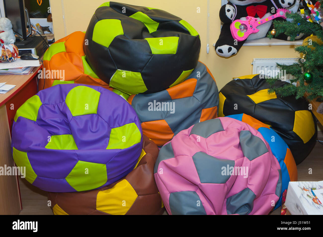 A huge, colorful pillows in a shape of balls, lying under a wall Stock ...