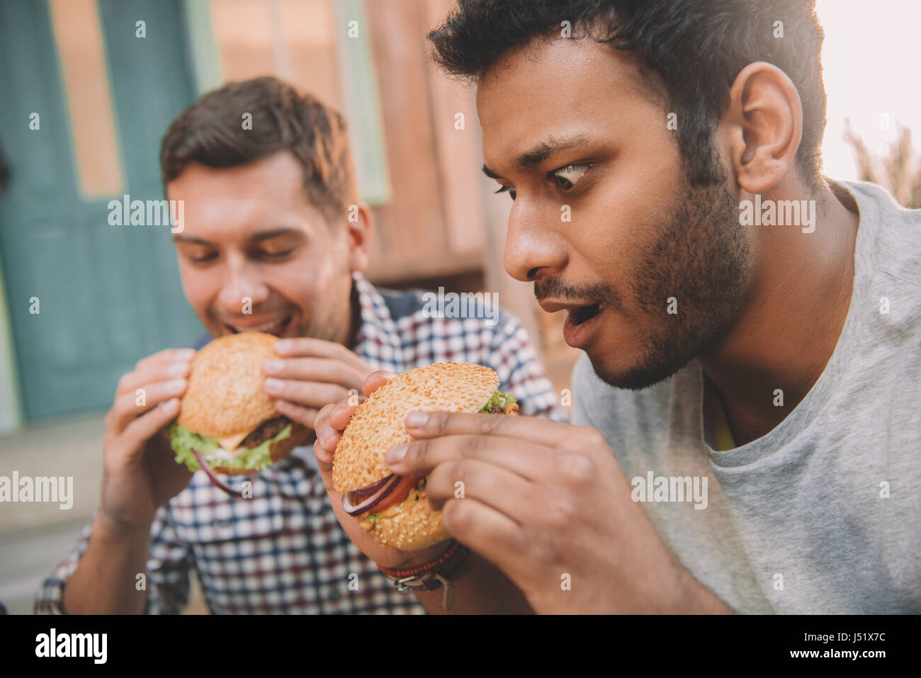 Young men eating hi-res stock photography and images - Alamy