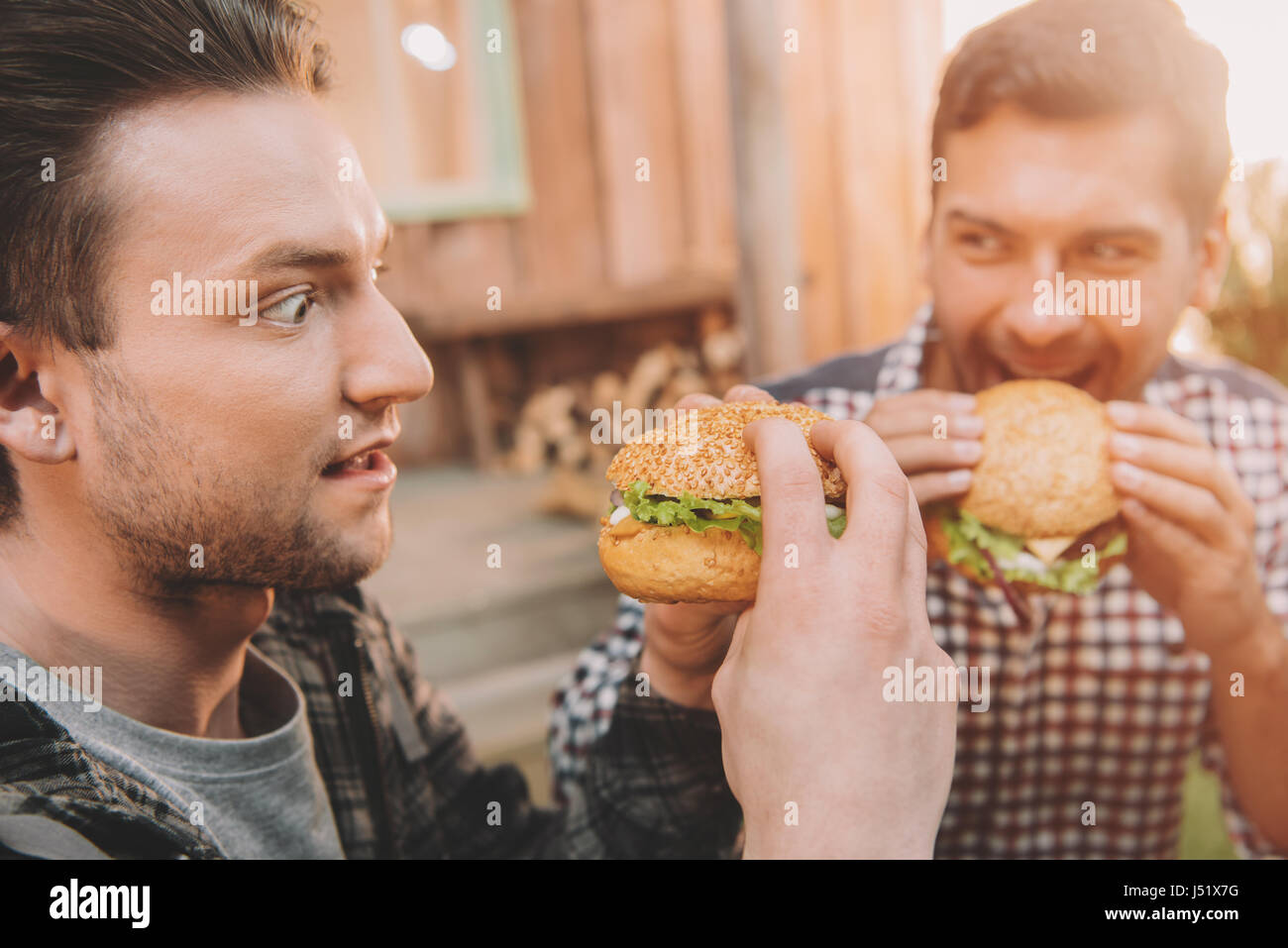 Young people eating burgers hi-res stock photography and images - Alamy