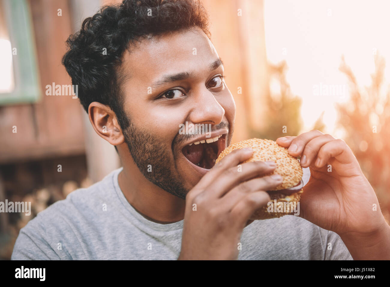 Biting into hamburger hi-res stock photography and images - Alamy
