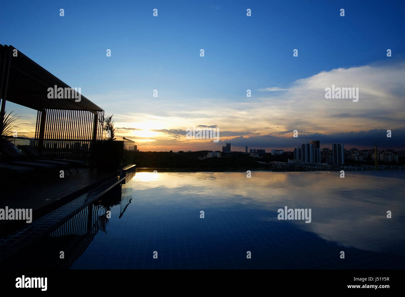 Swimming pool and sunset Stock Photo - Alamy