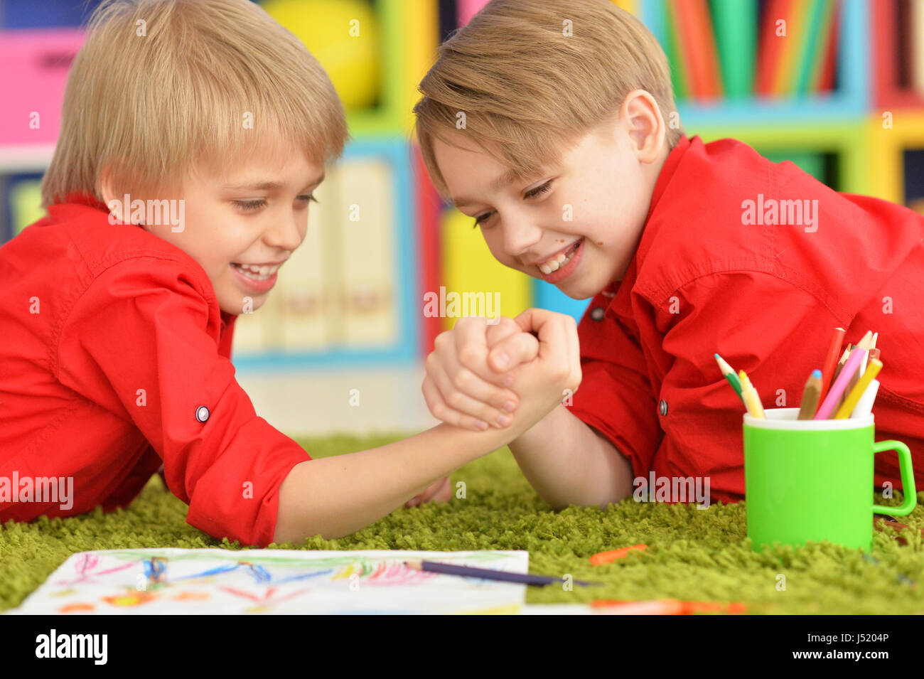 Two brothers draws with pencils Stock Photo - Alamy