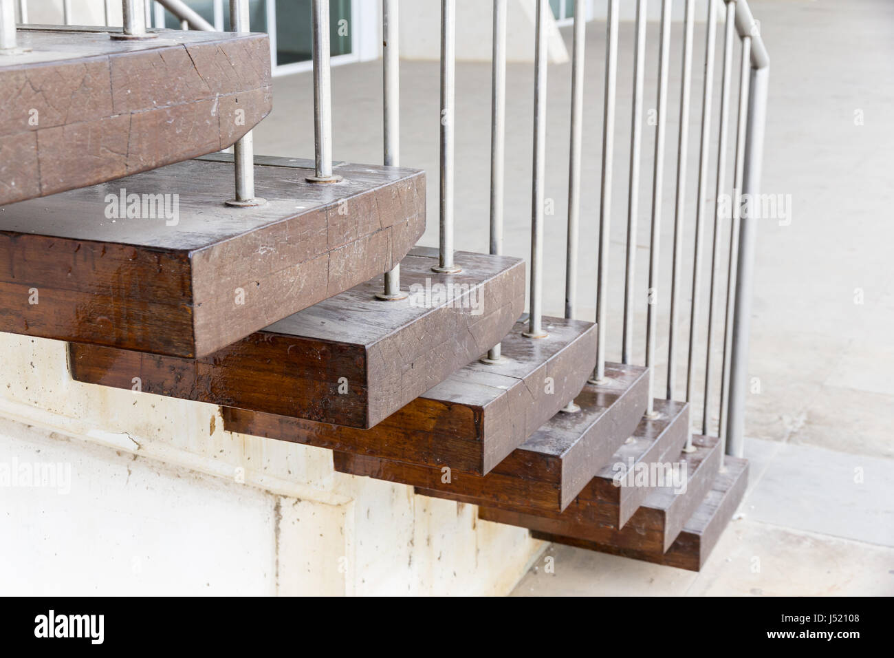 close-up of staircase with wooden steps and concrete base Stock Photo ...
