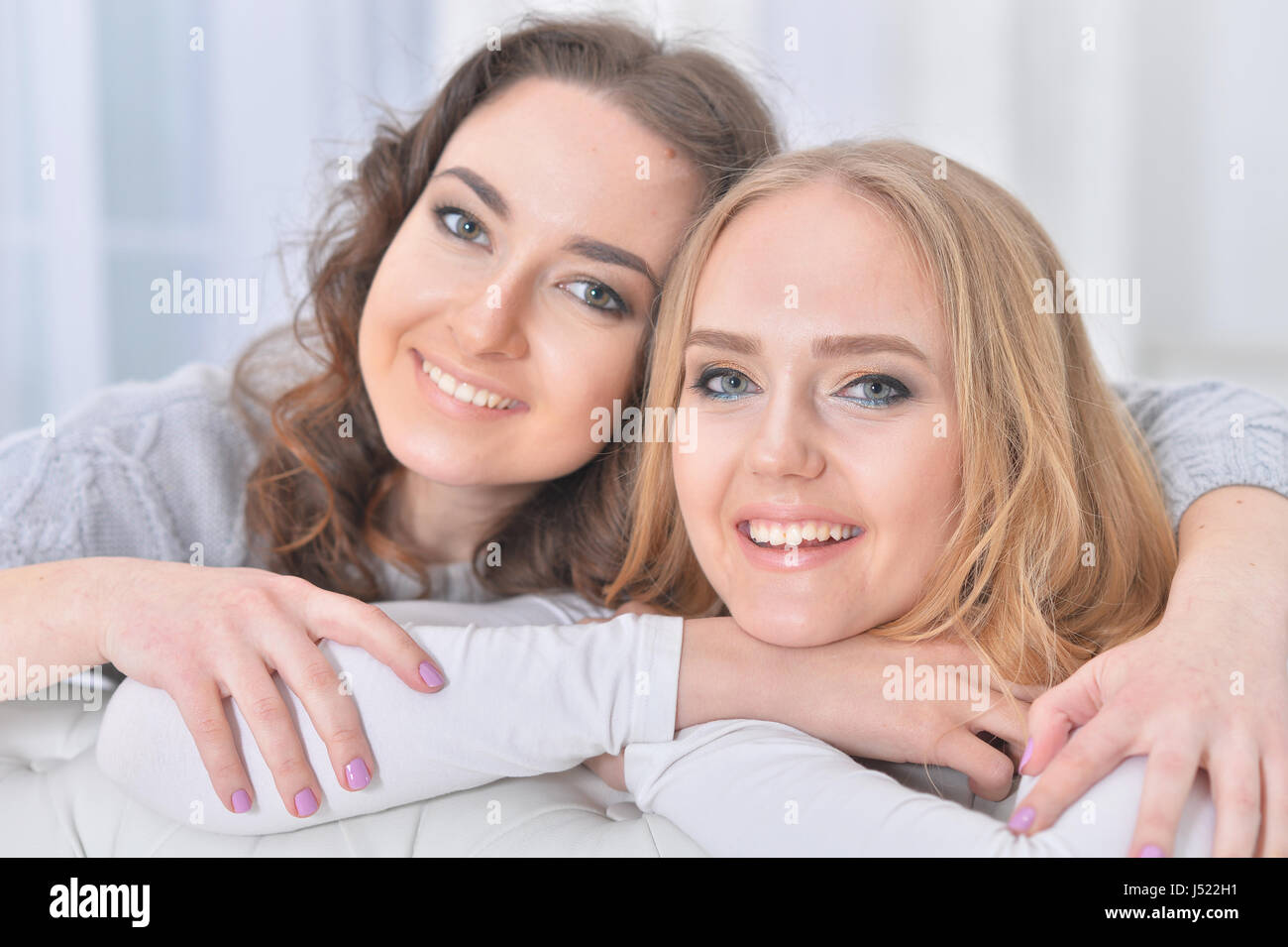 Embracing girlfriends close-up Stock Photo - Alamy