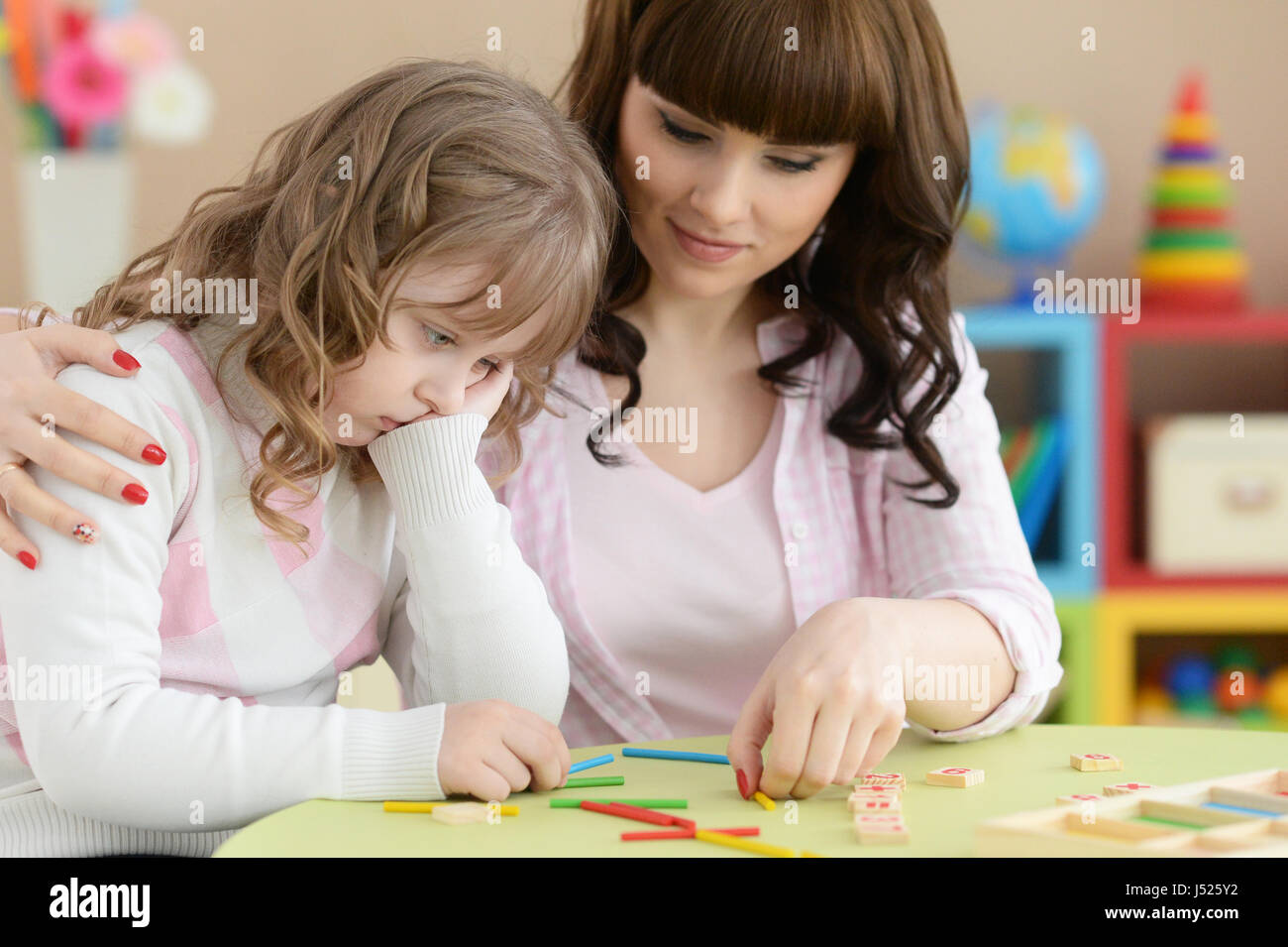 Mother and daughter doing lessons Stock Photo - Alamy