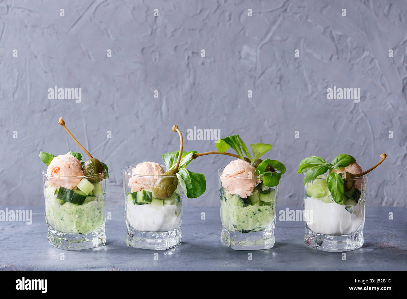 Verrines appetizer with salmon pate, red caviar, cucumber, cream cheese ...