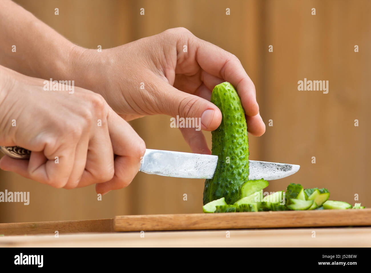 hands cutting fresh cucumber on the wooden chopping board Stock Photo ...