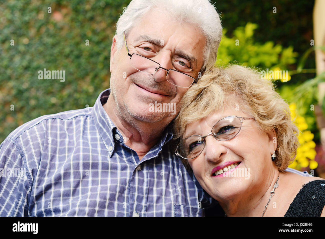 Portrait of an elderly couple sitting outdoors Stock Photo - Alamy
