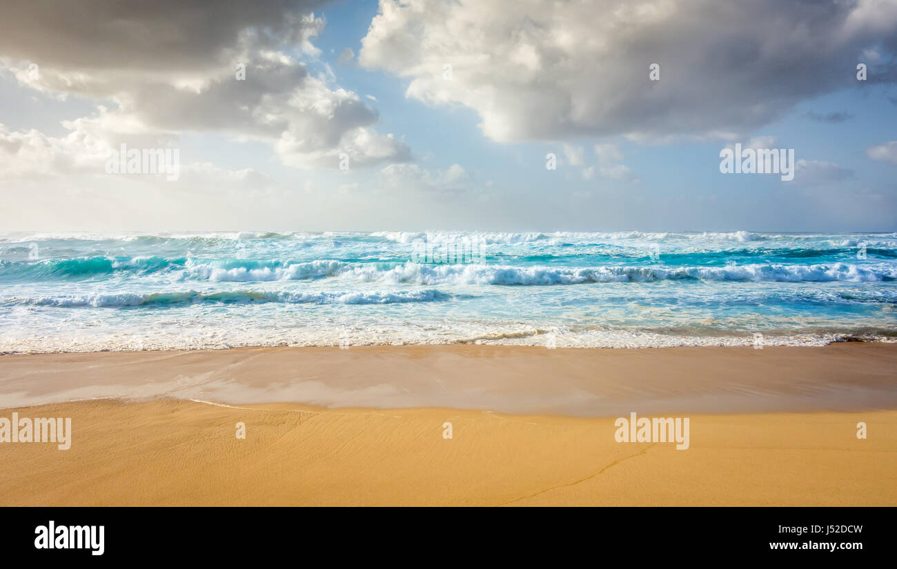 A wide view of large, powerful blue waves rolling in to Sunset Beach on ...