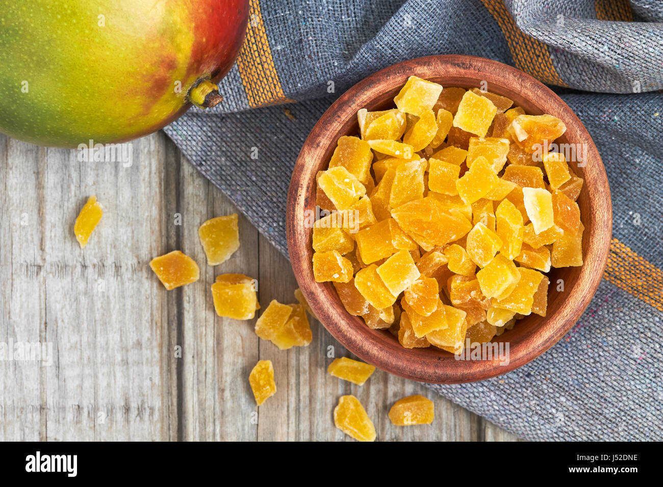 Dried and candied mango in wooden bowl. Top view with copy space Stock ...