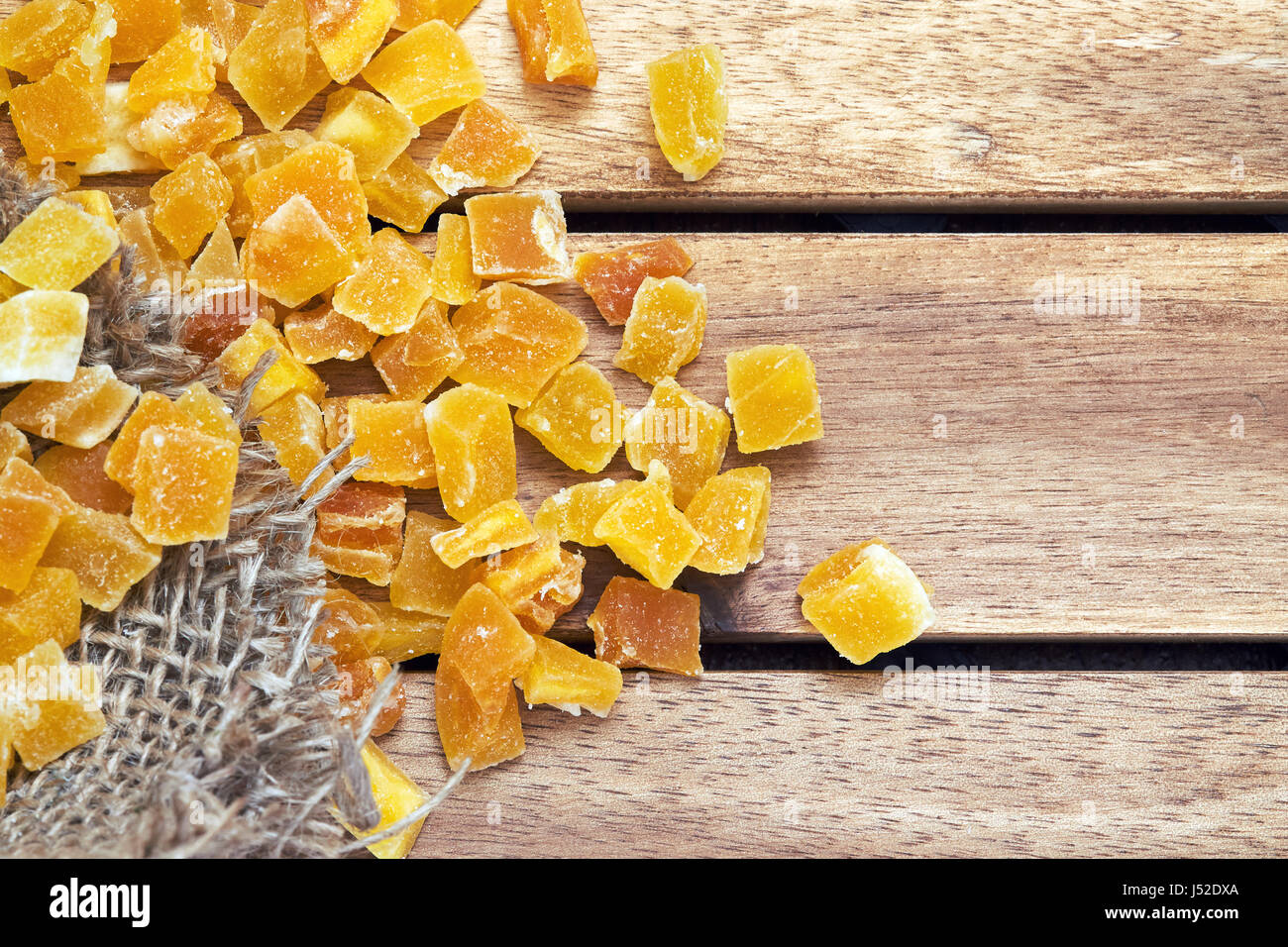 Dried and candied mango on wooden background. Top view with copy space ...