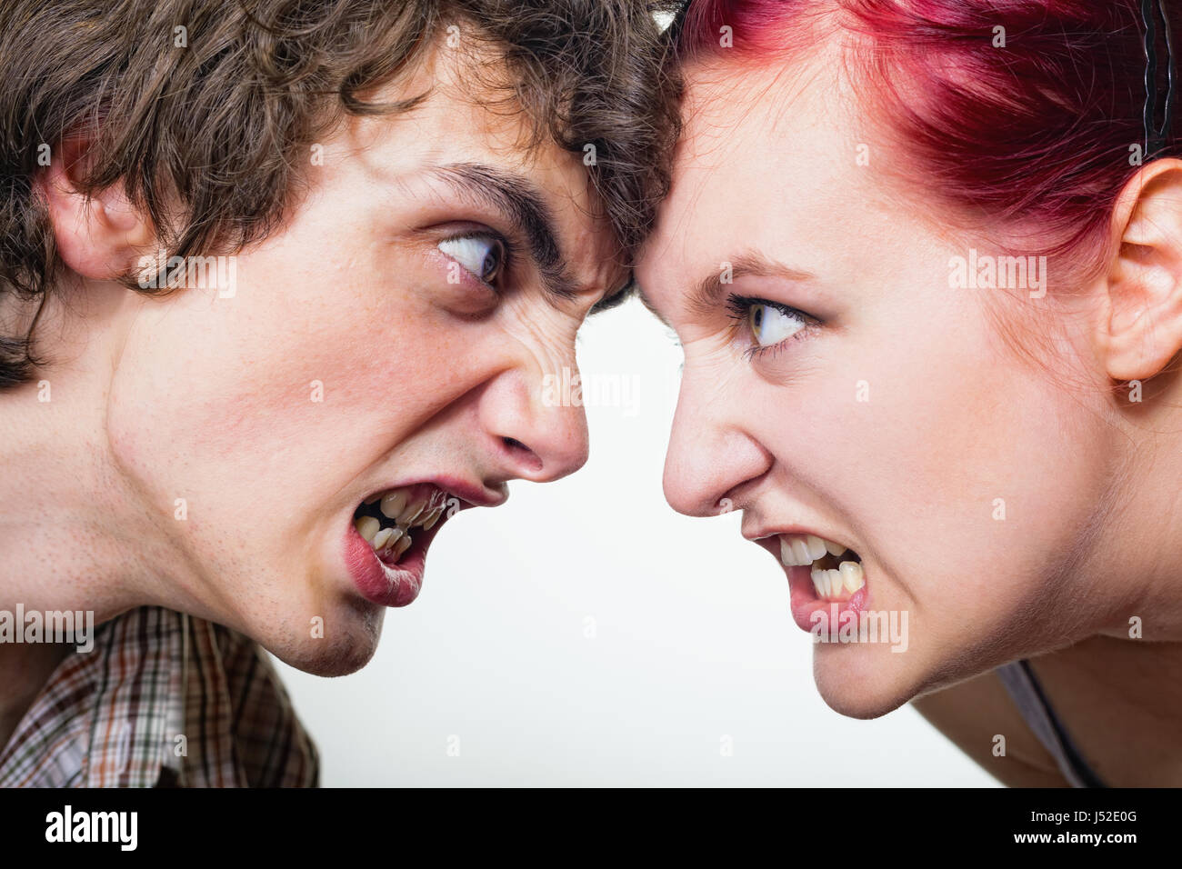Close-up portrait of a pair of angry shouting against each other on a ...
