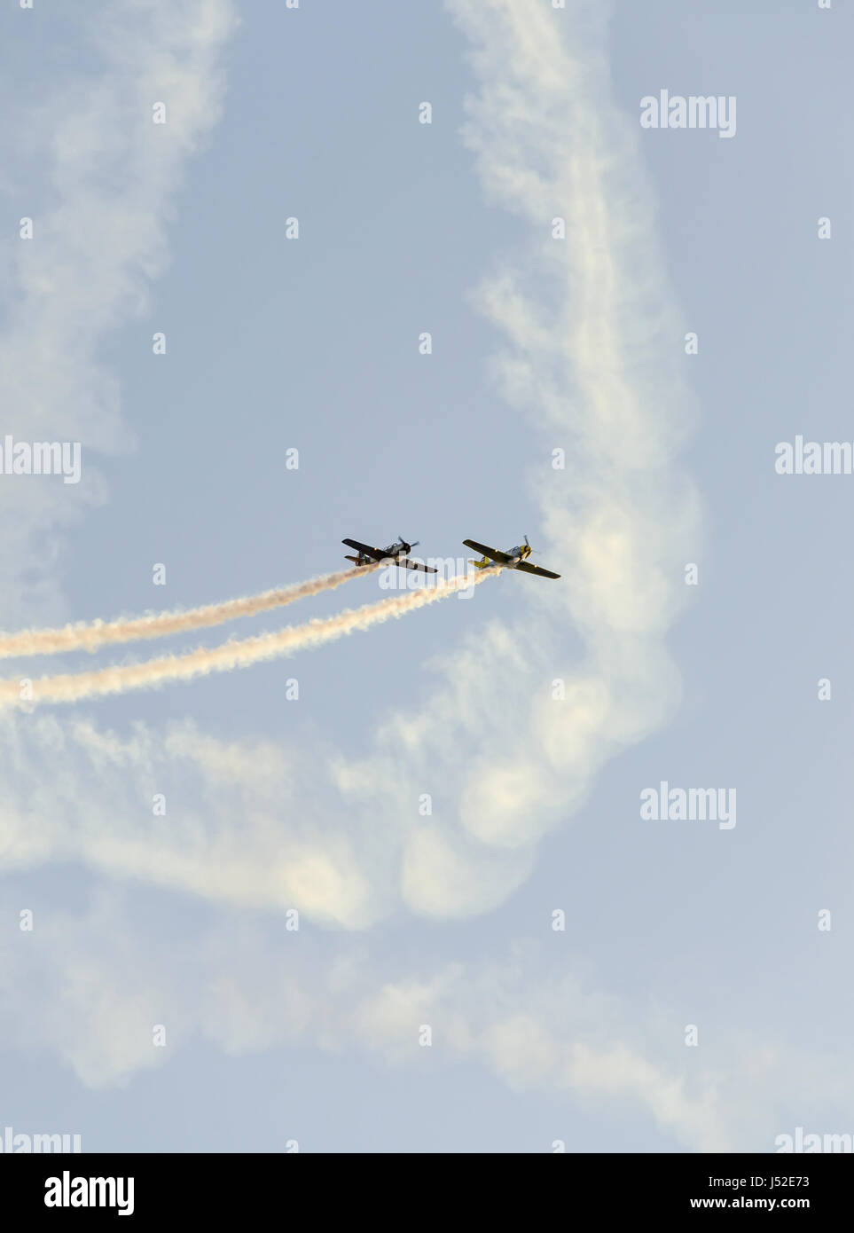 Aerobatic pilots with her colored airplanes training in the blue sky ...