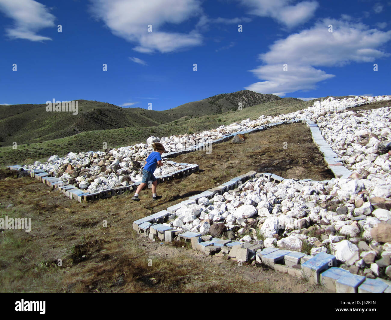 Boy running up a hill in the middle of an arrow pointing upward to the ...