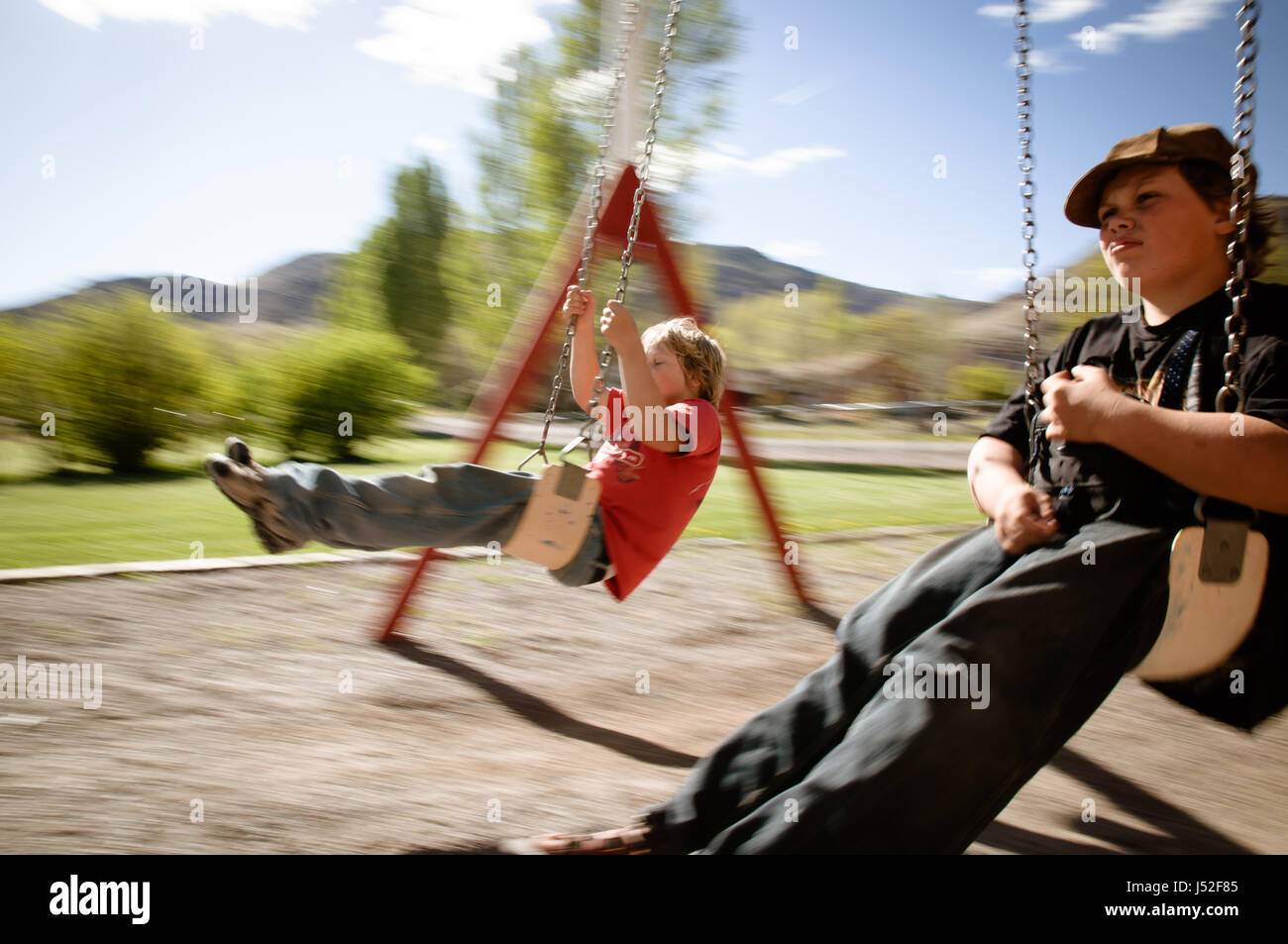 Two boys playing on swing hi-res stock photography and images - Alamy