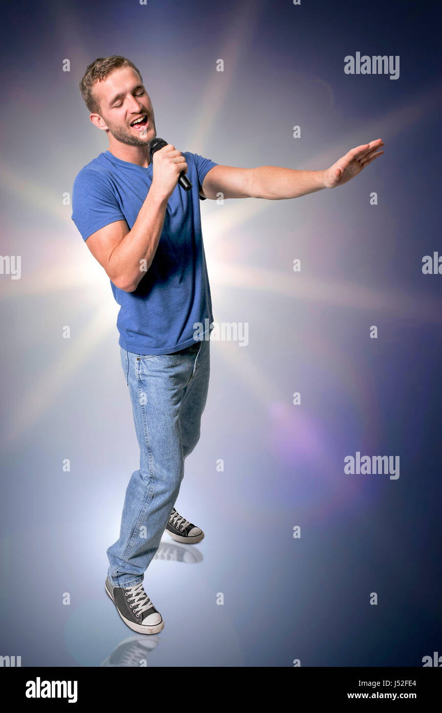 Handsome man singer performing at a concert Stock Photo - Alamy