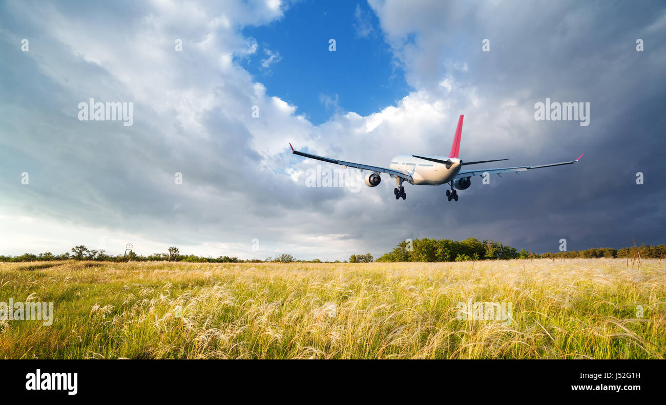 Airplane. Landscape with big white passenger airplane is flying in the ...