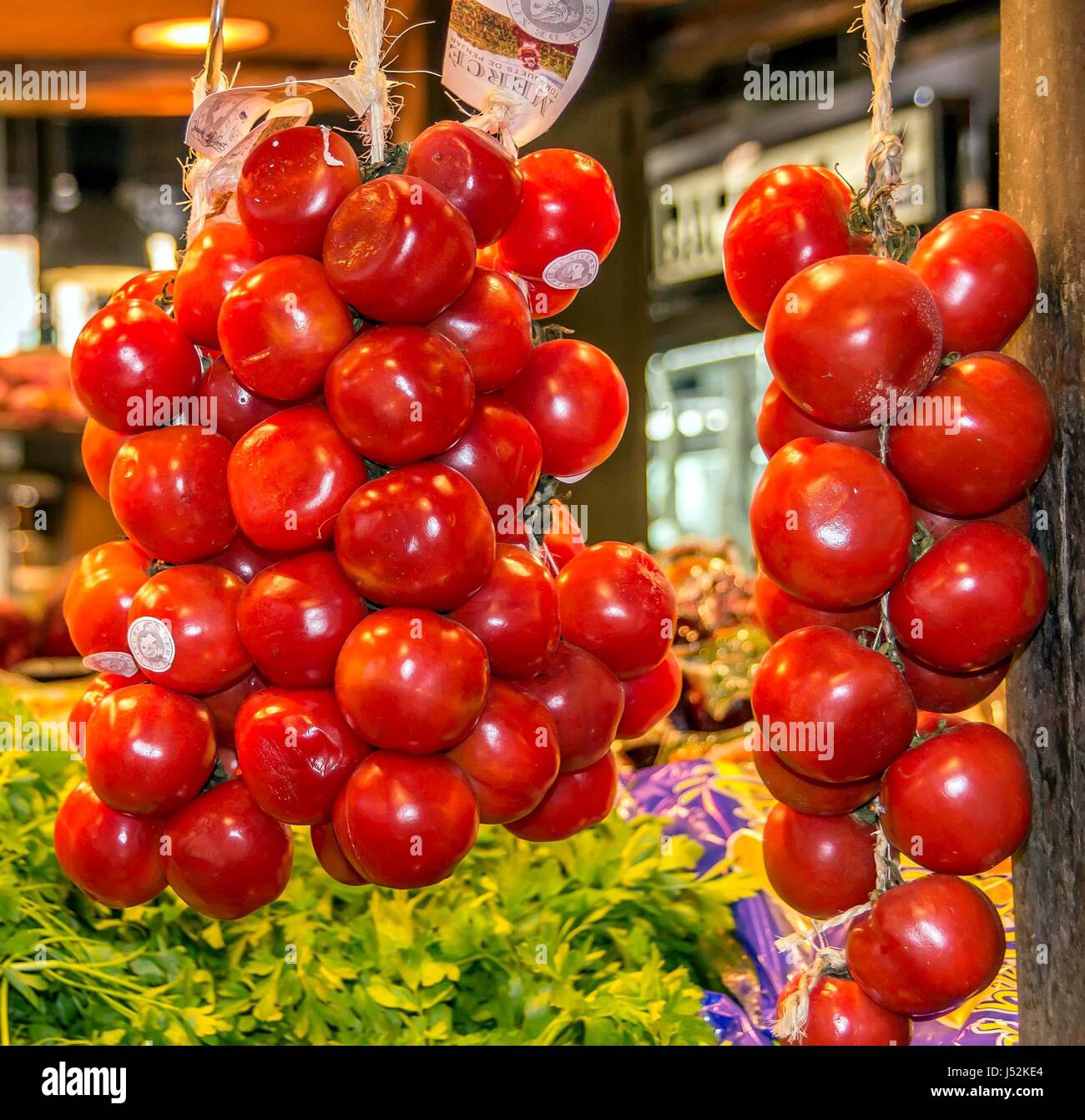 Hanging tomatos on display at a vegetable market in Barcelona, Spain ...