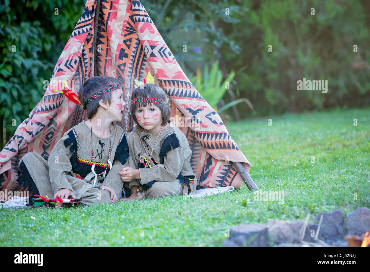 Cute portrait of native american boys with costumes, playing outdoor ...