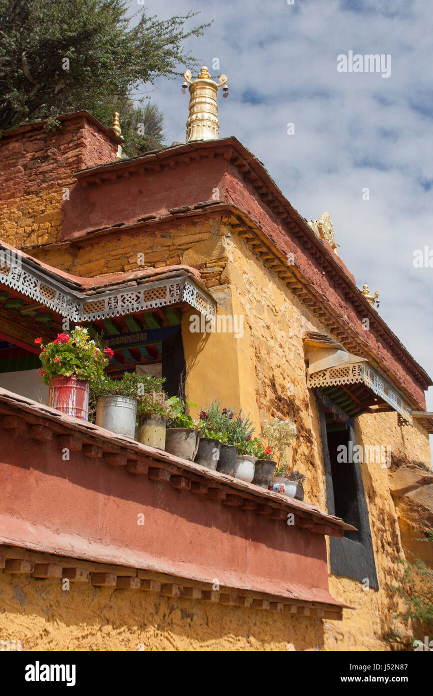 Golden dhvaja on roof line of Ganden Monastery, Lhasa, Tibet, shot in ...