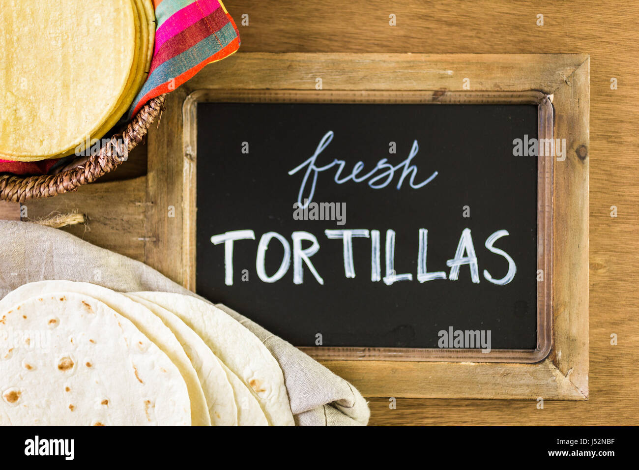 Variety of fresh tortillas on a wood background Stock Photo - Alamy
