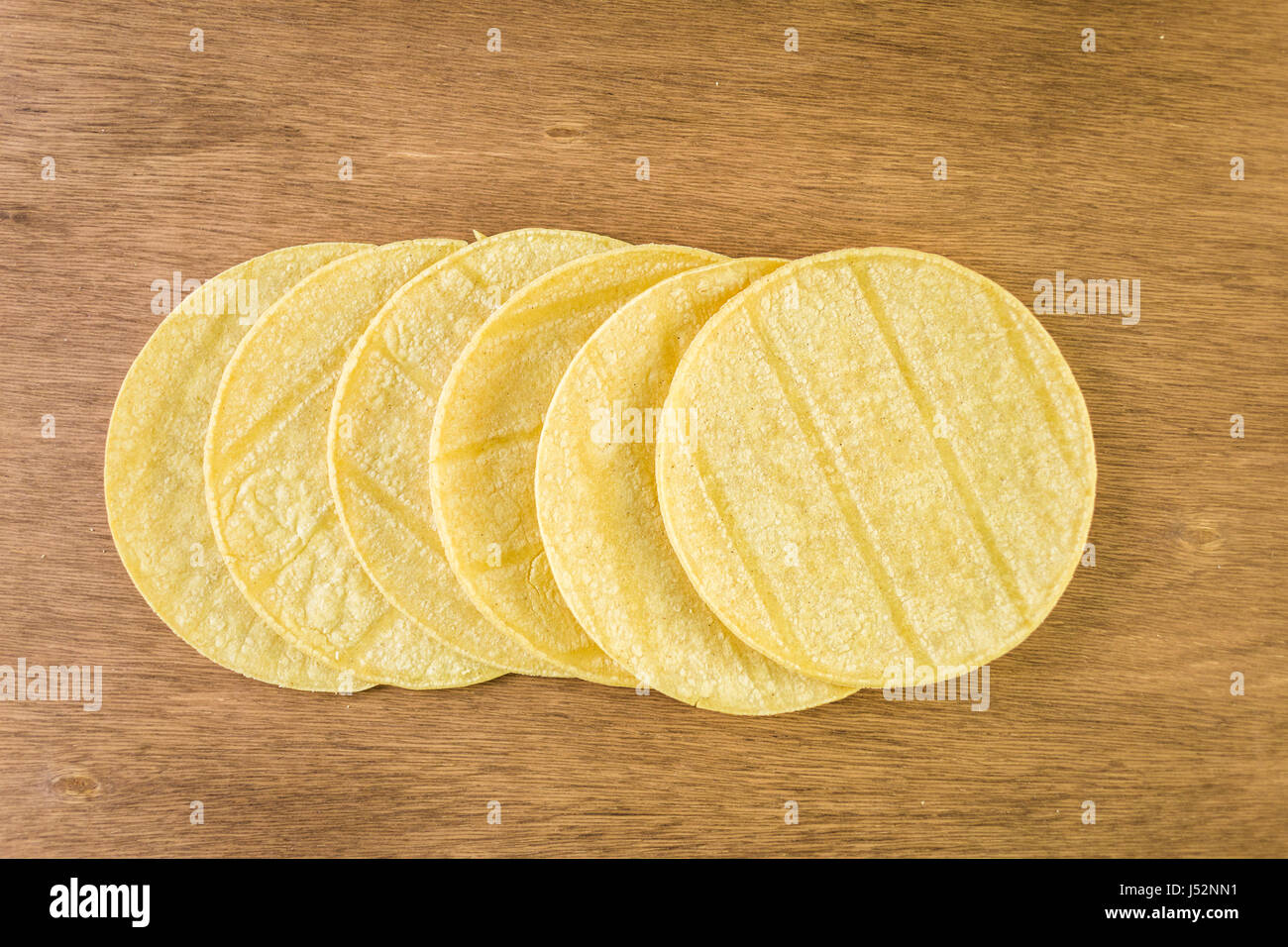 Fresh yellow corn tortillas on a wood background Stock Photo - Alamy