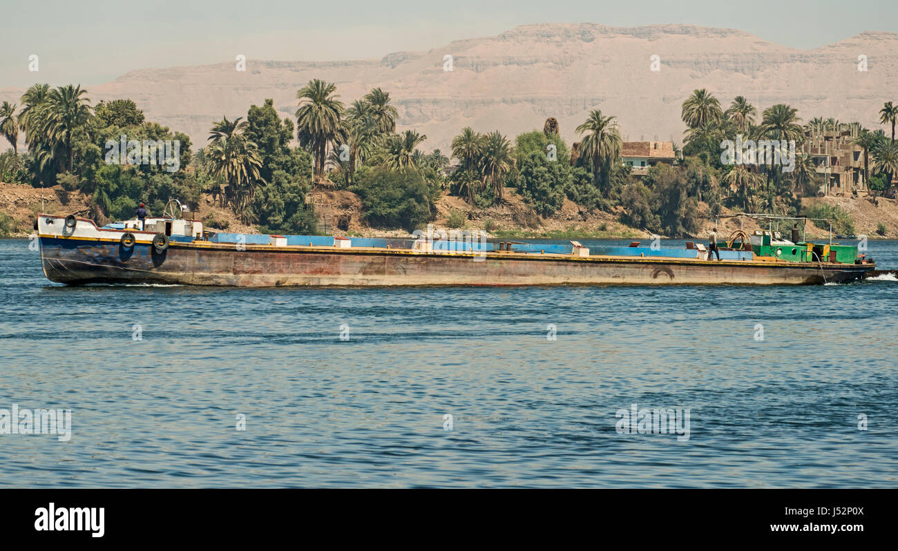 Old traditional barge boat traveling on river Nile through rural ...