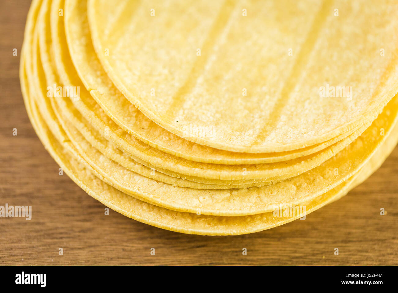 Fresh yellow corn tortillas on a wood background Stock Photo - Alamy