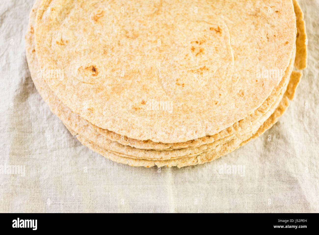 Fresh multi-grain tortillas on a linen dinner napkin Stock Photo - Alamy