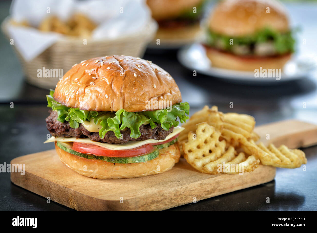 Beef with cheese burger with potato chips Stock Photo - Alamy