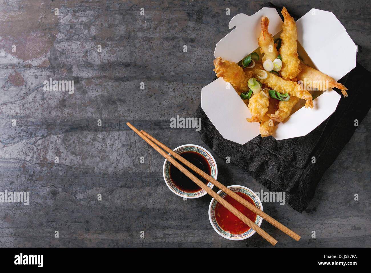 Fried tempura shrimps with rice and spring onion in paper to-go box ...
