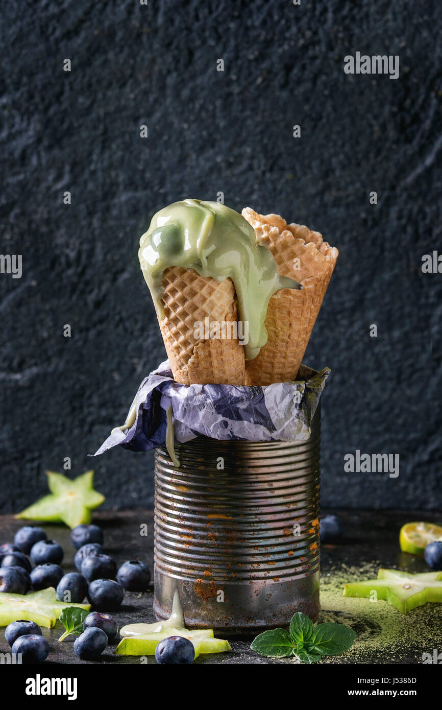 Waffle cones of Green tea matcha soft elastic ice cream with mint ...
