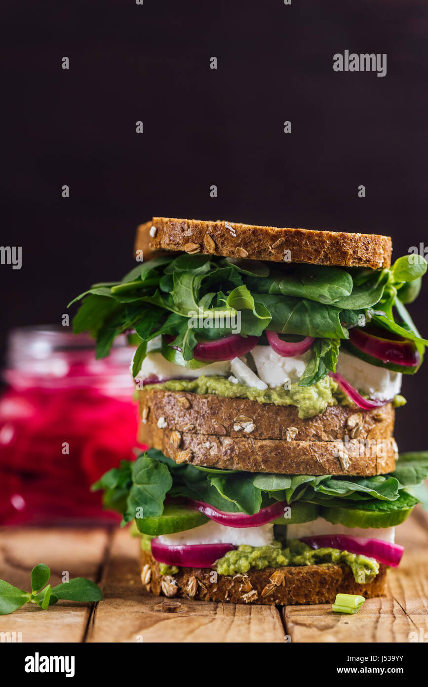 A stack of springtime feta sandwiches with avocado, pickled red onions ...