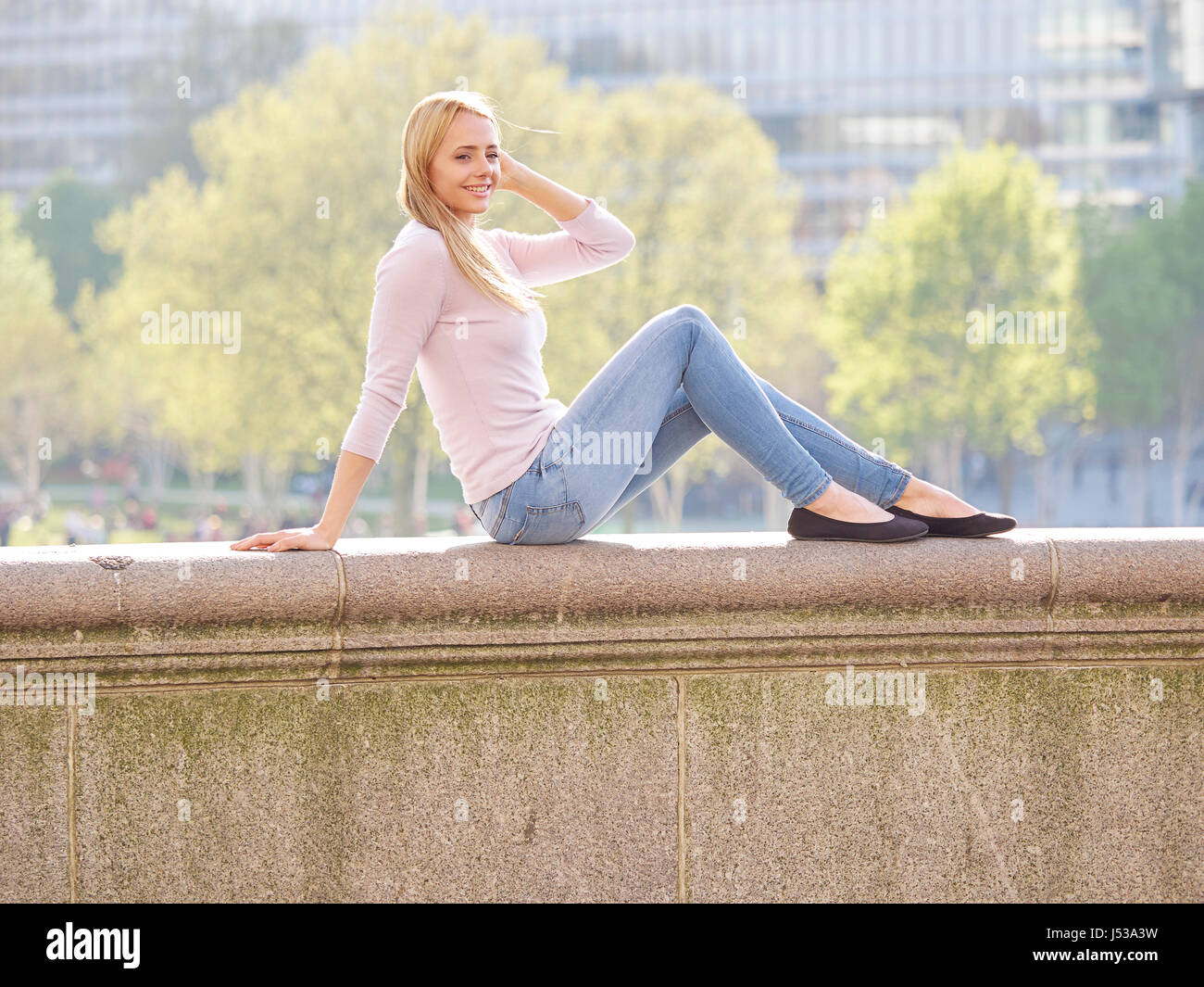 Young woman relaxes in the sunshine Stock Photo - Alamy