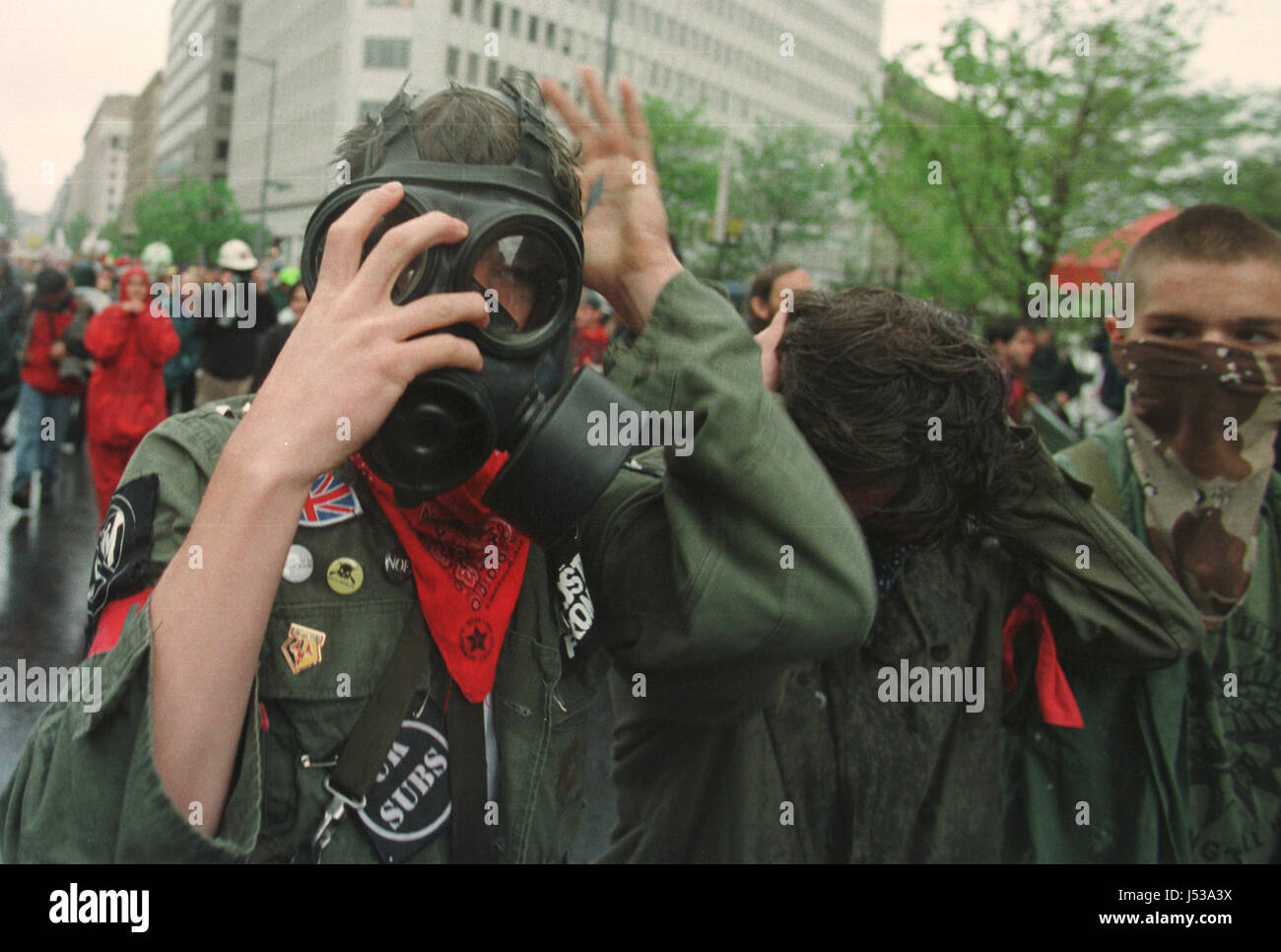 Punk rock protester adjusting mask. Protesters block streets and ...