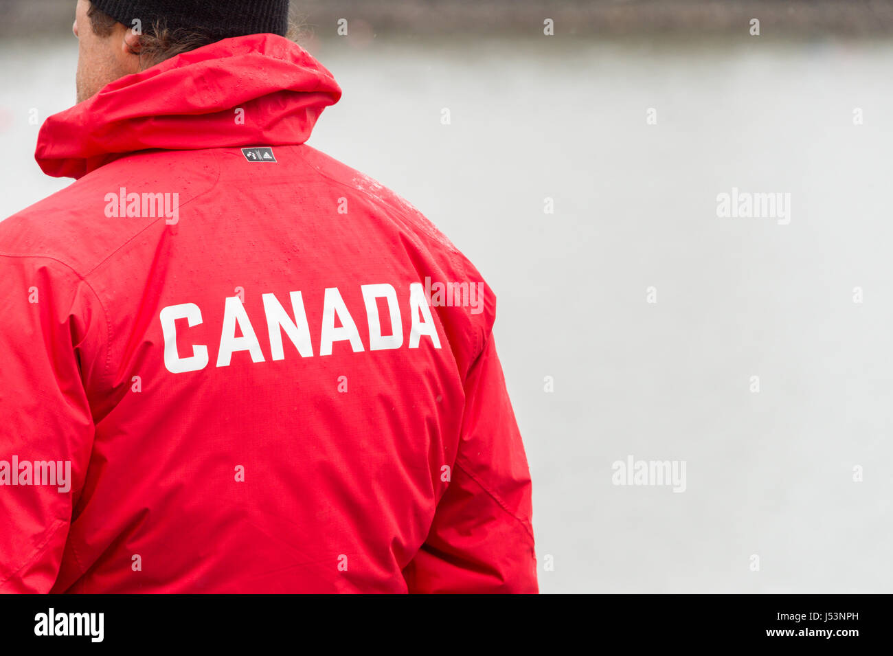 Man wearing a red jacket with the word "Canada" in white Stock Photo ...