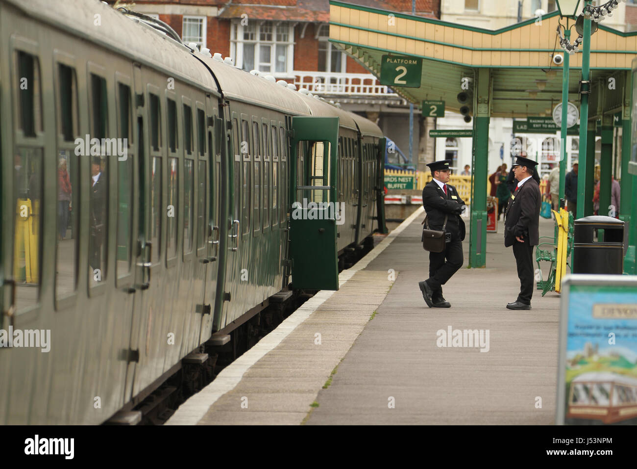 Swanage, UK - 12 May: Two Swanage Railway guards seen on the platform ...