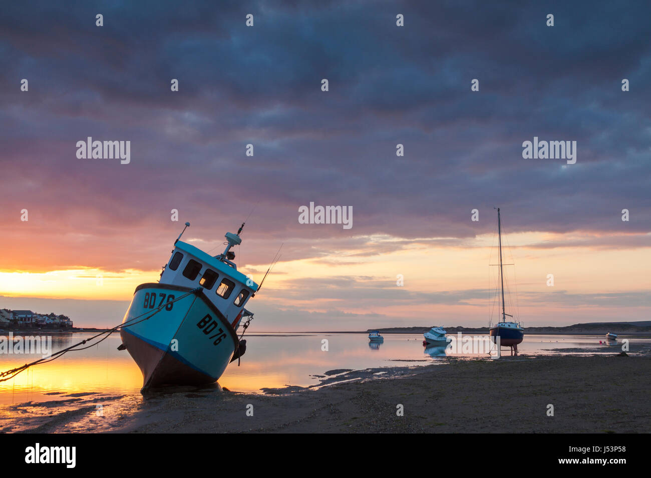 A stunning sunset scene at Instow beach, North Devon. boats are on the ...