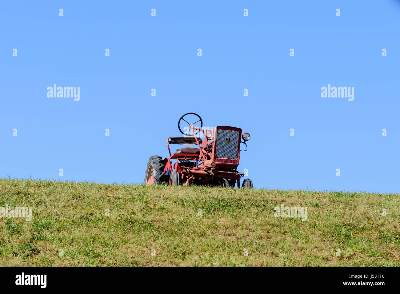 Tractor on a hill Stock Photo - Alamy