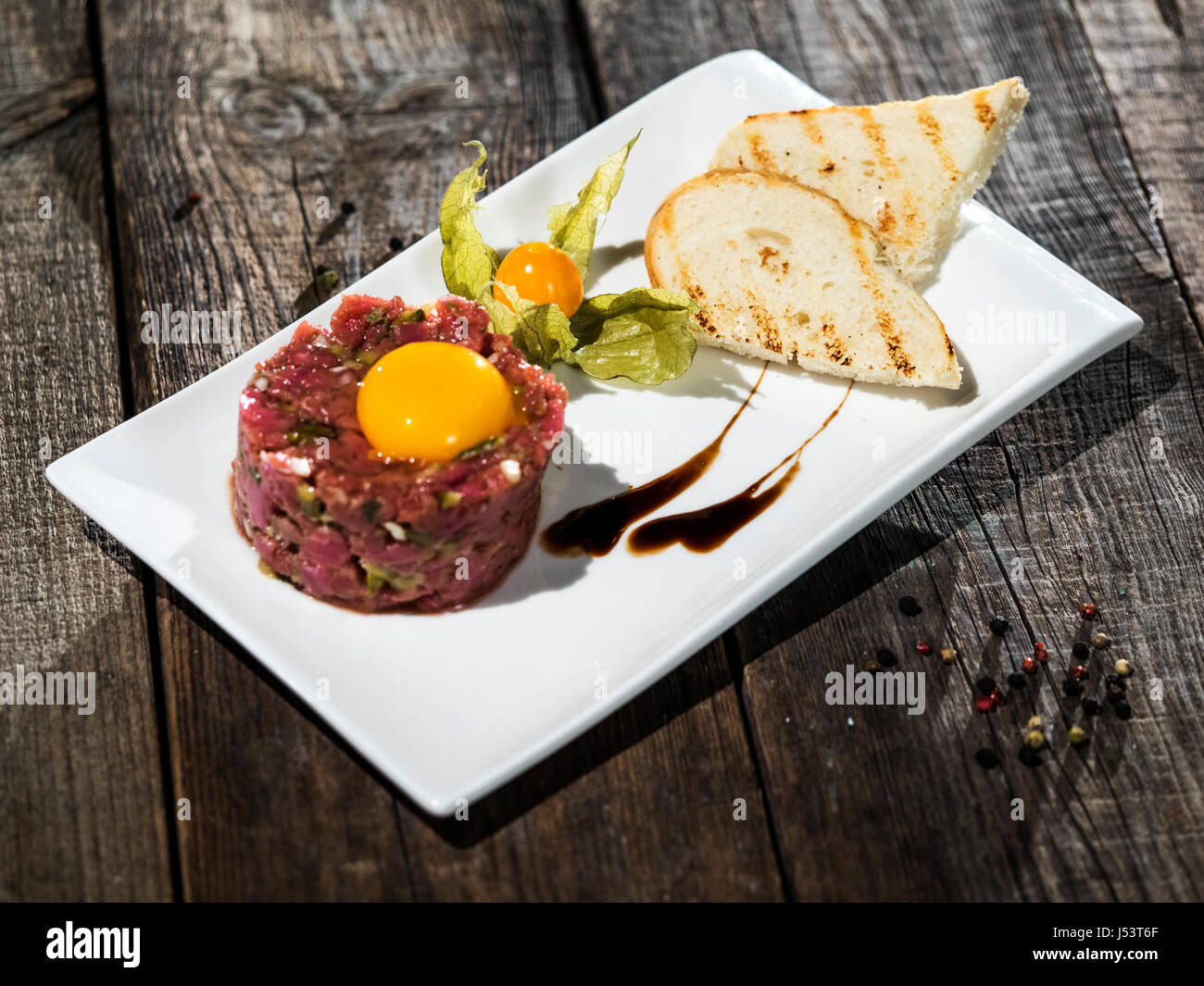 Raw steak tatar with egg yolk Stock Photo - Alamy