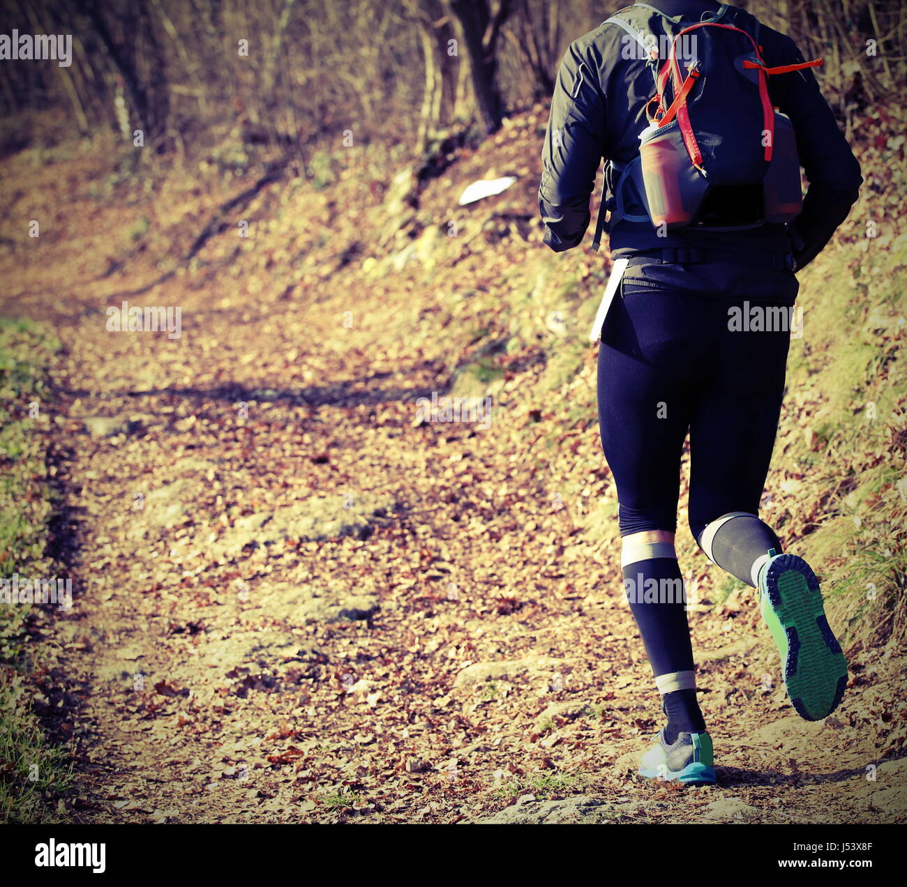 athlete runner from behind during racing on the mountain trail Stock ...