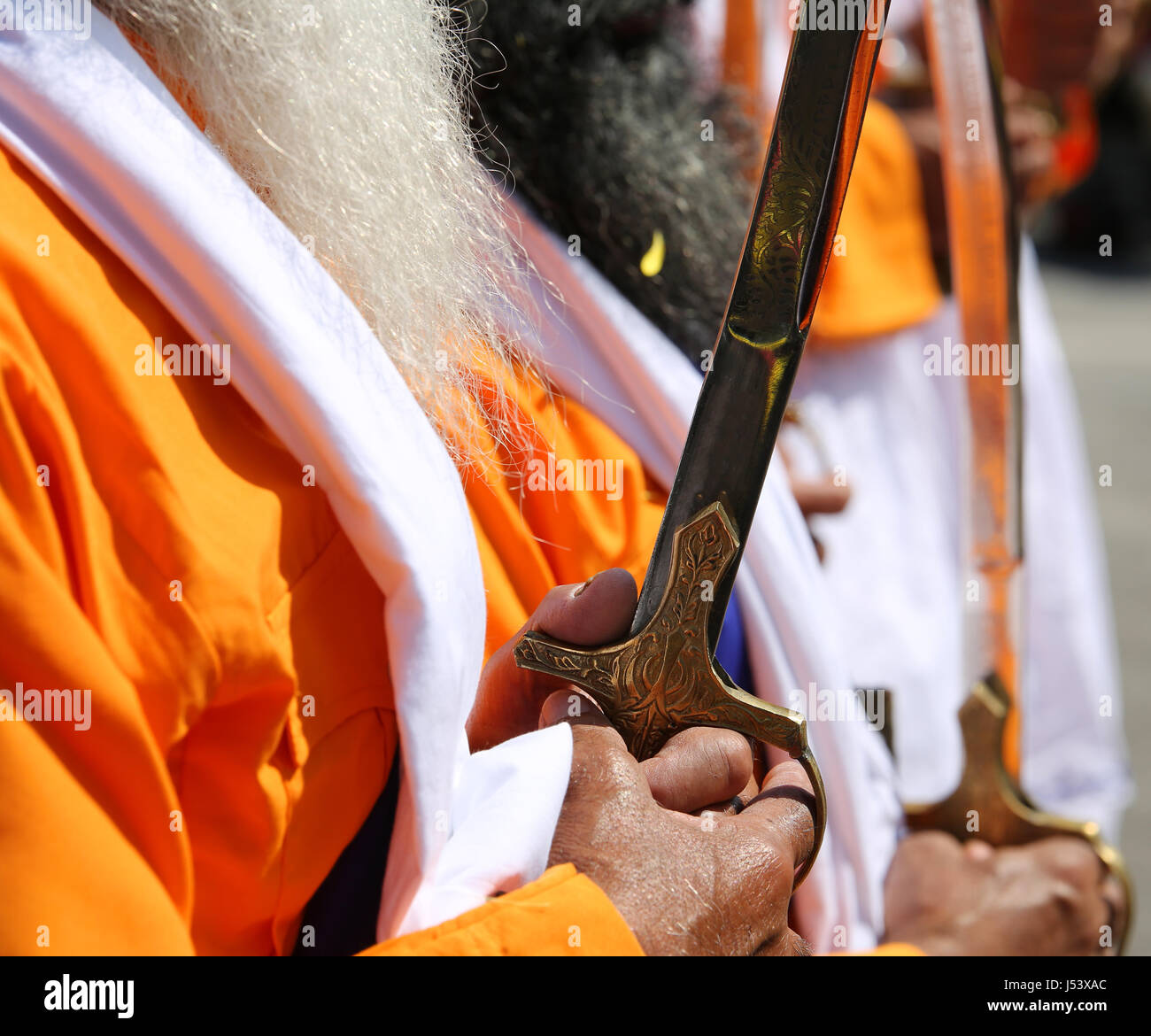 Sikh senior man with the long white beard and a sword during religious ...