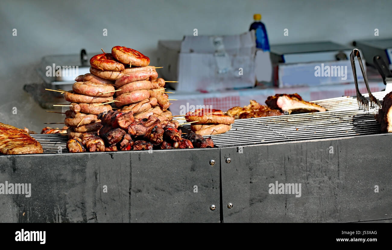 street food stall with big grilled sausages and other cooked meat Stock ...