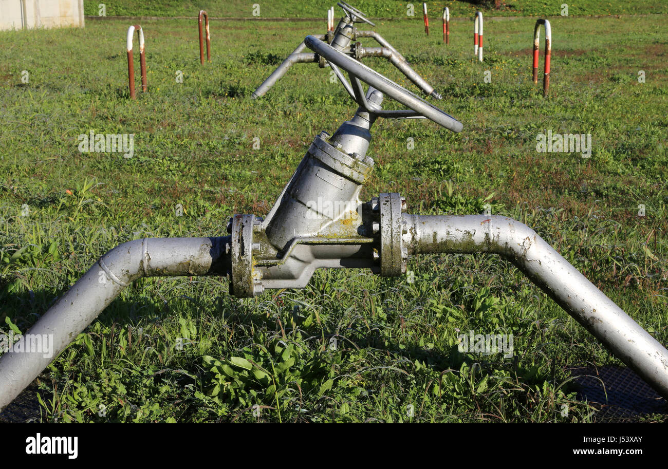 tap with pipe closure valve in a large industrial plant photographed ...