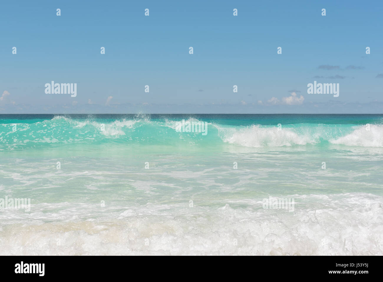 Surf on tropical beach Stock Photo - Alamy