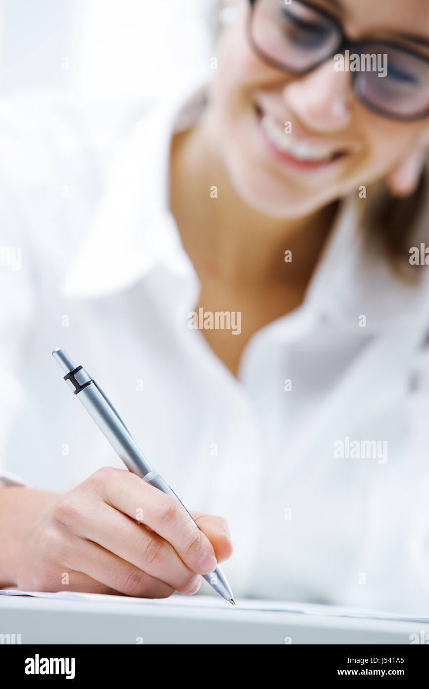 Business woman writing on a document, hand close up Stock Photo - Alamy