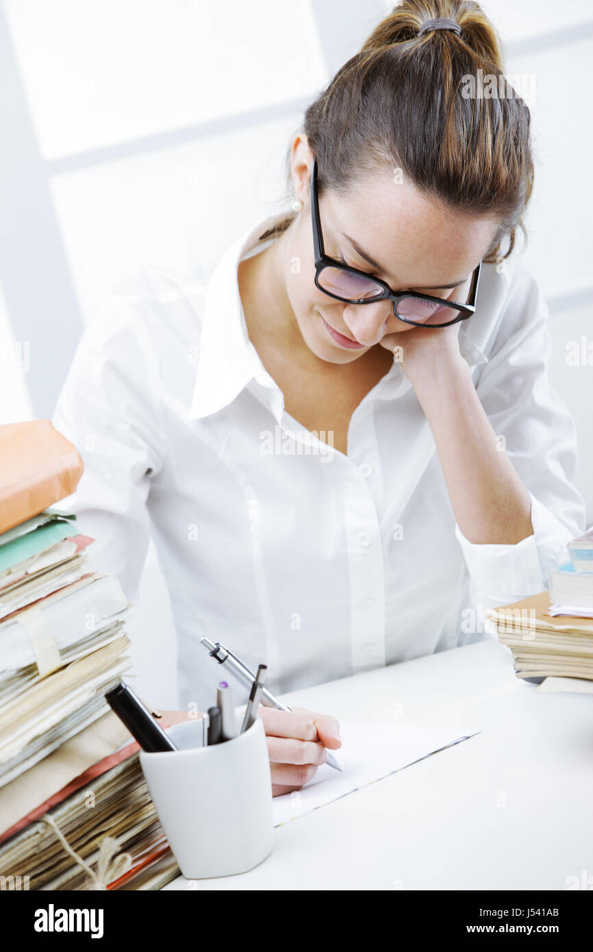 Business woman taking notes in office Stock Photo - Alamy