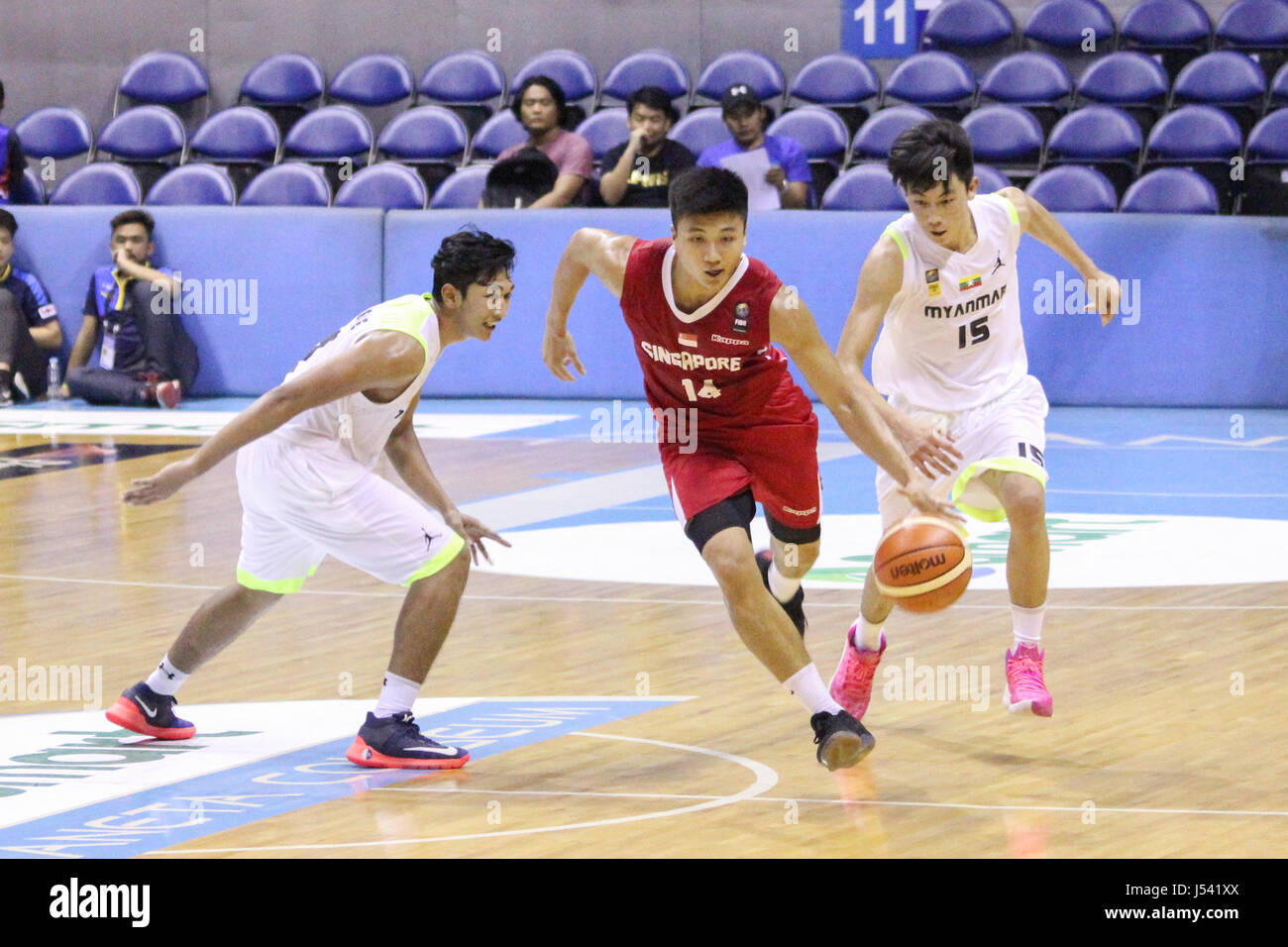 Zao Chia (14) of Singapore drives past his two guards from Myanmar ...