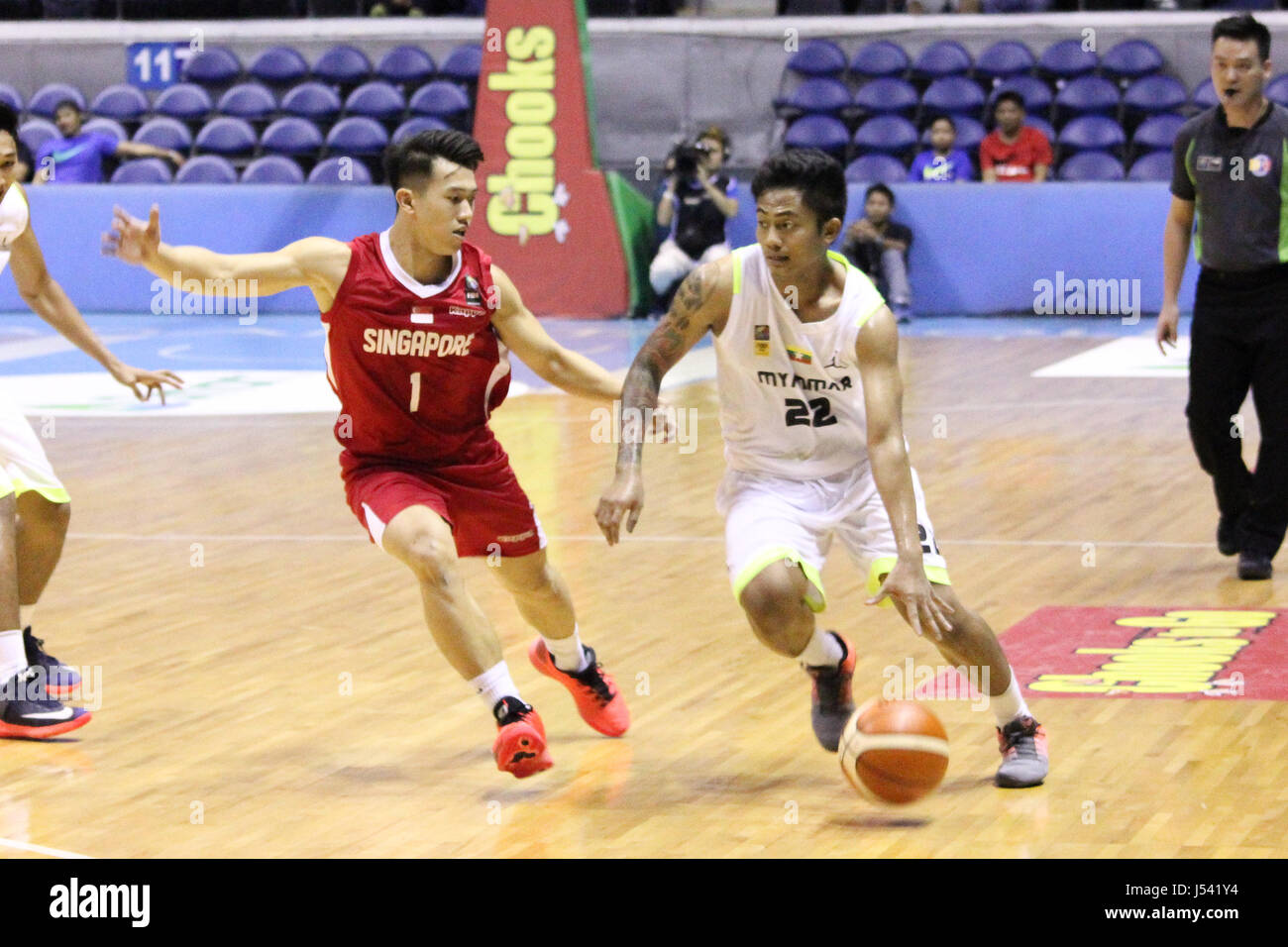 Sei Thu Tun Tun (22) of Myanmar drives the ball past guard Lim Jun Yuan ...